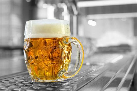 Freshly Poured Draft Lager Beer In A Dimpled Glass Mug On Stainless