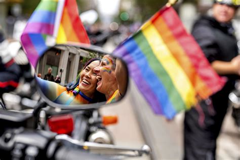 Lgbtq Pride Revelers Flash Feathers And Flags In The Streets From New