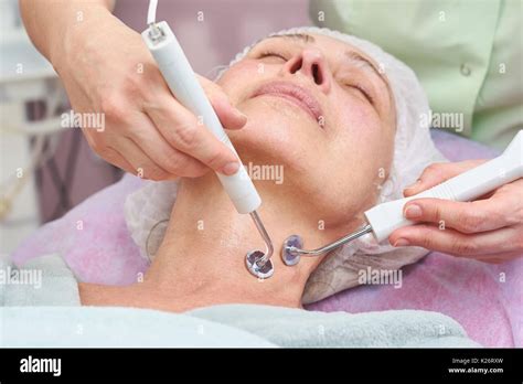 Microcurrent Therapy Device Hands Of Cosmetician Adult Woman Stock