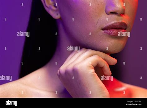 Close Up Of Biracial Woman With Dark Hair Red Lips And Hand To Face On