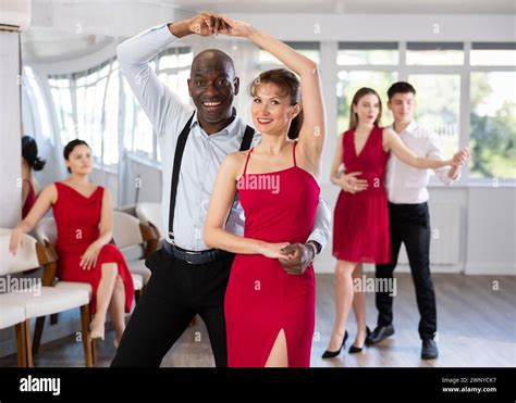 Young Dancing Multinational Couple Enjoying Active Swing Dance In