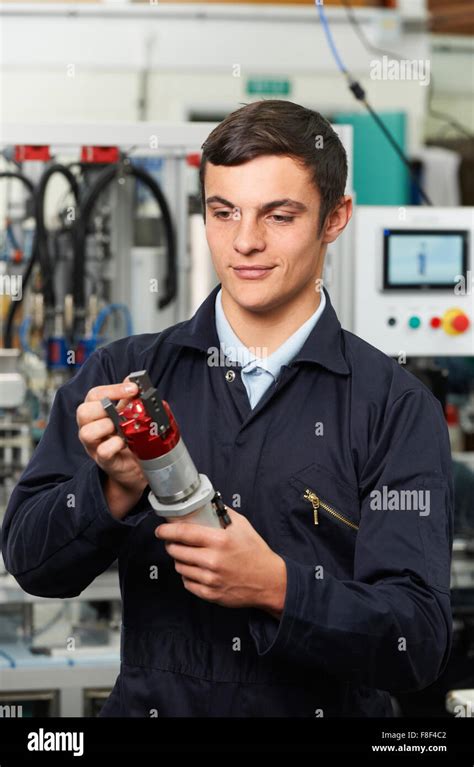 Trainee Engineer Checking Component In Factory Stock Photo Alamy