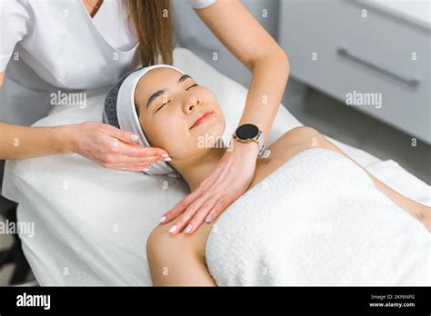 Attractive Pure Skinned Asian Woman In Her 20s Lying Down On Her Back