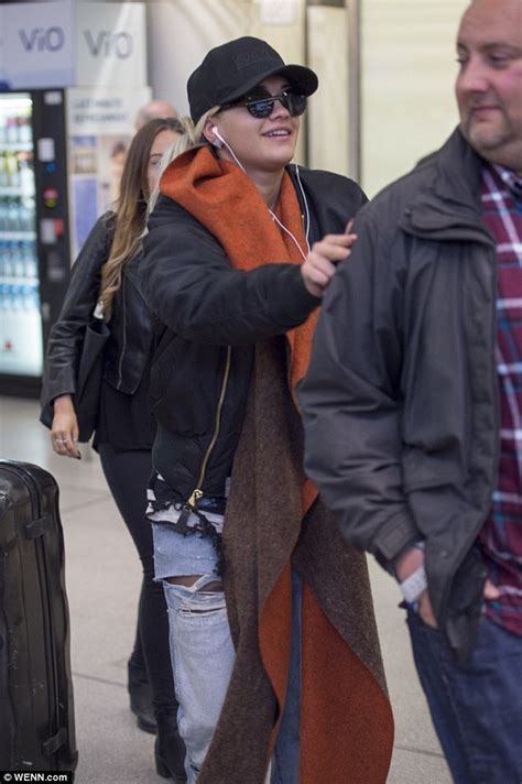Rita Ora Covers Up In A Scarf And Bomber Jacket To Jet Out Of London