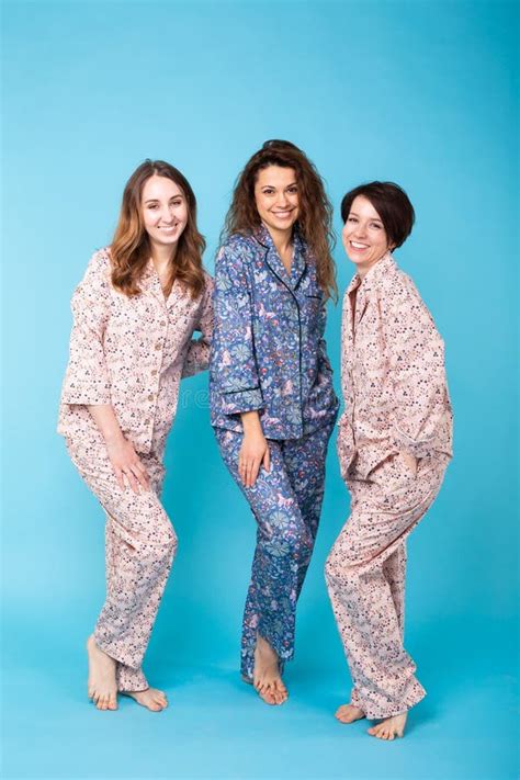Portrait Of Three Beautiful Young Girls Wearing Colorful Pyjamas Having