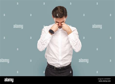 Portrait Of Sad Depressed Crying Man With Mustache Standing And Rubbing