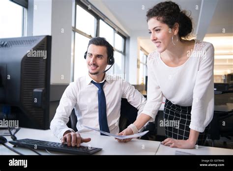Two Colleagues Analysing Business Data On A Computer In An Office