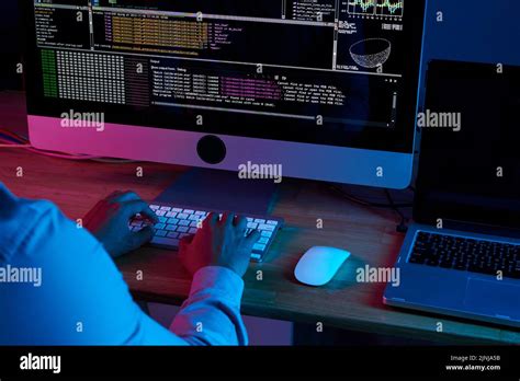 Close Up Shot Of Unrecognizable Programmer Wearing White Shirt Sitting In Front Of Modern