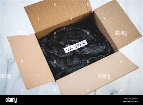 Low Stock Text Inside Of Empty Delivery Parcel With Black Padding On