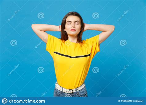 Portrait Of Relaxed Young Woman In Vivid Casual Clothes Keeping Eyes