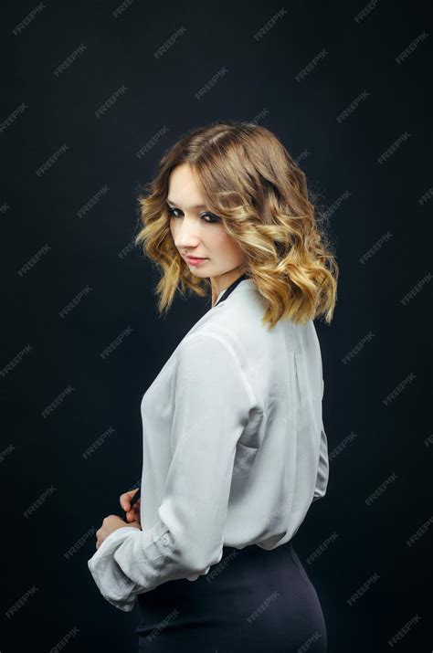 Premium Photo | Fashionable sexy girl poses in a dark studio