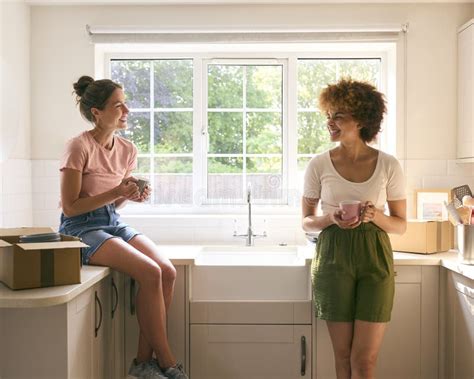 two female friends or same sex couple taking a coffee break from