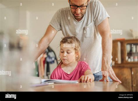 Father Checking Homework Of His Daughter Stock Photo Alamy