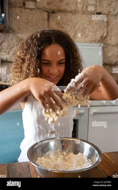 Funny African American Girl Cooking A Dessert In The Kitchen Of Her