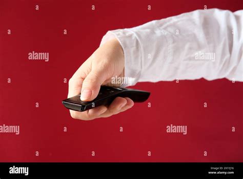 Female Hand Holds Remote Control Joystick From Tv Presses The Button