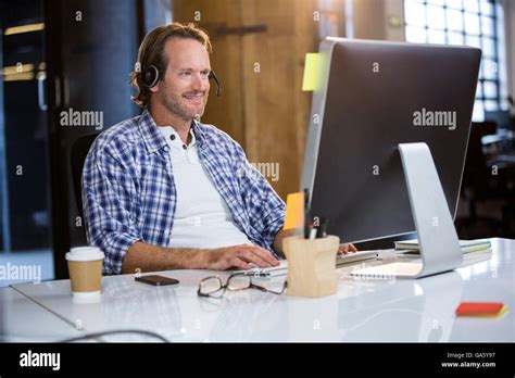 Businessman Smiling While Using Computer Stock Photo Alamy