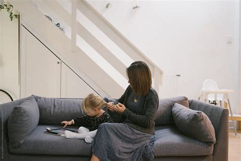 Mother Brushing Daughters Hair By Stocksy Contributor Bruce And