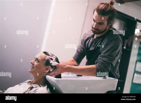 Young Woman Getting New Hairstyle At Professional Hair Styling Saloon