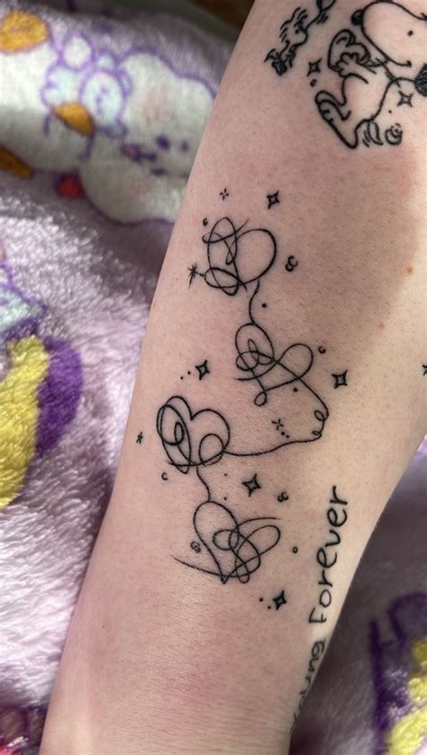 A Person S Arm With Tattoos On It And The Word Love Is Written In Black Ink