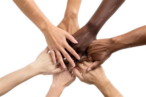 Hands Of Various Skin Tones Joined Together On A White Background