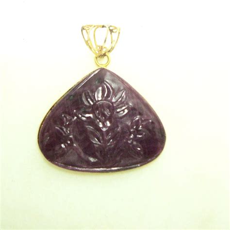 Ruby Carved With Gold Framing Tushargems Medium