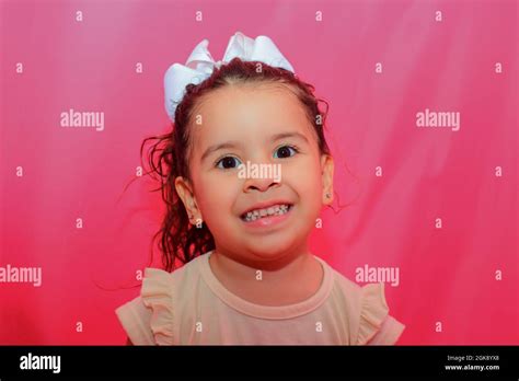 Cute Happy Small Argentinean Girl Standing On Pink Background Stock