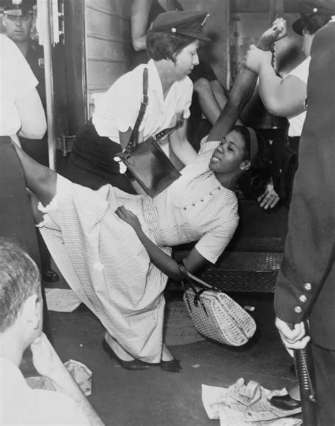 African American Woman Being Carried To Police Patrol Wagon During