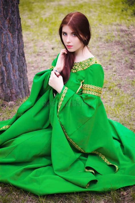 Beautiful Young Red Haired Girl In A Green Medieval Dress With Long
