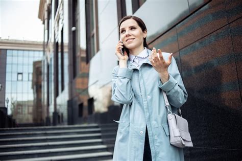 Premium Photo Cute Woman Emotionally Talking On The Phone On The