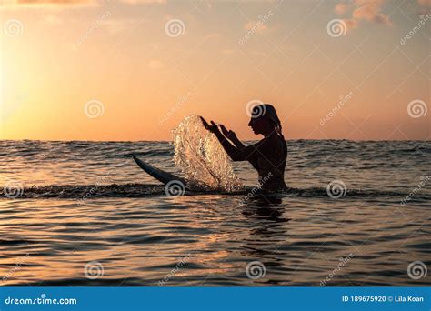 Portrait From The Water Of Surfer Girl With Beautiful Body On Surfboard