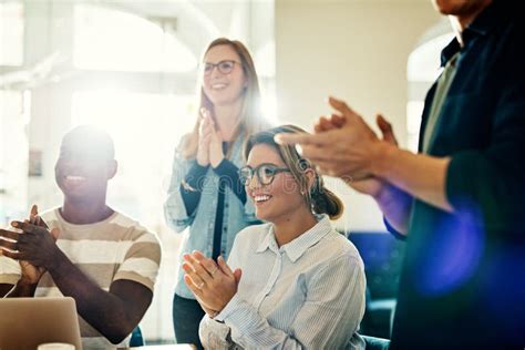 Smiling Group Of Diverse Coworkers Clapping During An Office