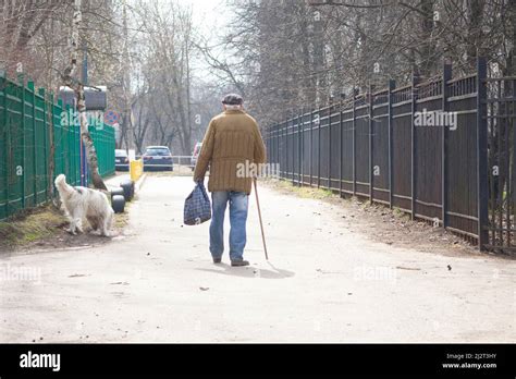 Pensioner In Russia Grandpa Walks Down Street Old Man With Support