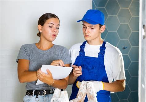 Contractor Discussing Apartment Renovation Work Plan With Woman