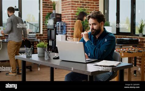 Office Worker Planning Startup Presentation With Charts On Laptop