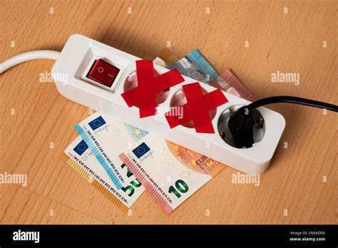 Electrical Extension Cord With Three Outlets Lies On Banknotes Two Sockets Sealed With Red