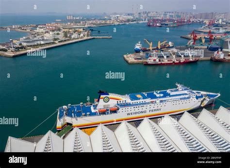 An Aerial View Of A Cruise Harboring At Qingdao Cruise Terminal