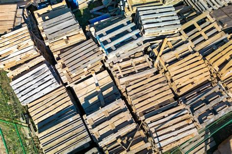 Premium Photo Empty Wooden Pallets Stacked On Construction Site Storage Area For Used Pallets