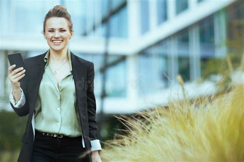 Happy Business Woman In Business District Using Smartphone Stock Image