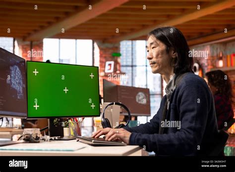 Senior Programmer Using Chroma Key Computer To Oversee Artificial Intelligence Neural Networks