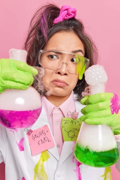 Free Photo Woman Works In Scientific Laboratory Holds Two Glass