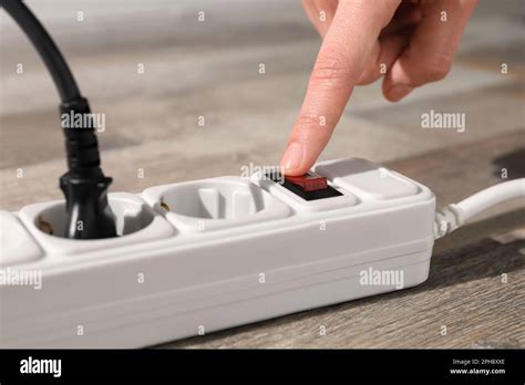 Man Pressing Power Button Of Extension Board On Floor Closeup Stock Photo Alamy