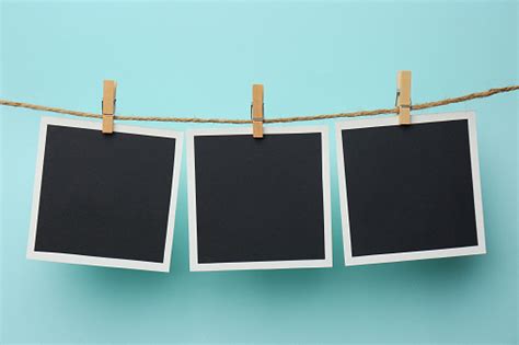 밝은 파란색 배경에 꼬기에 빈 인스턴트 프레임이 있는 나무 빨래집게 텍스트를 위한 공간 사진 이미지에 대한 스톡 사진 및 기타