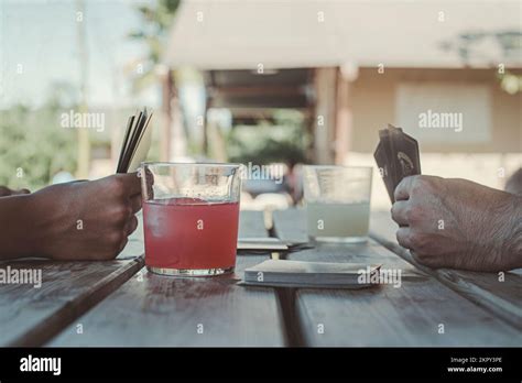 Two People Sitting At A Table Playing A Game Of Cards Stock Photo Alamy