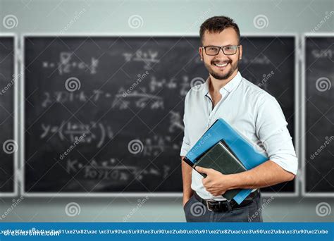 Portrait Of A Young Male Teacher On The Background Of The School