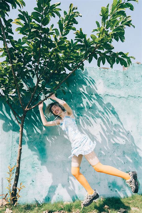 Fashion Woman Shaking A Tree Outdoor By Stocksy Contributor Pansfun Images Stocksy