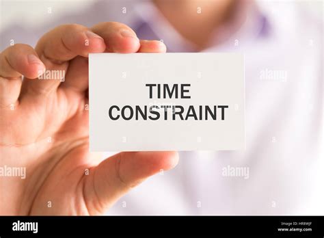 Closeup On Businessman Holding A Card With Time Constraint Message