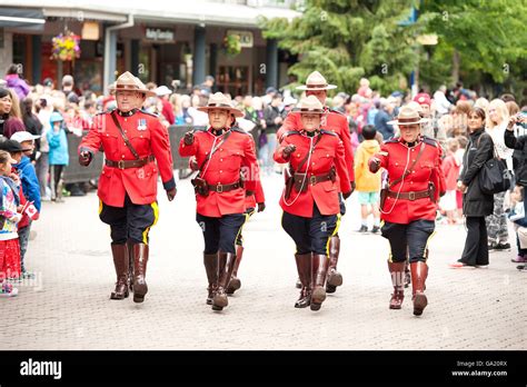 A Troop Of Rcmp Police Officers In Traditional Red Serge March In The