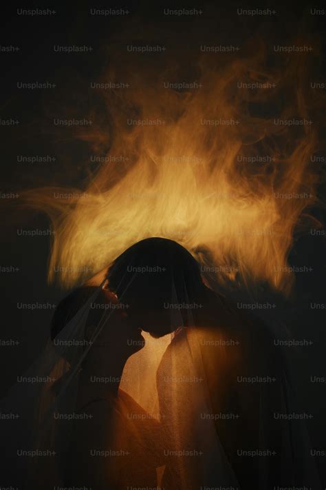 A Man And A Woman Kissing In Front Of A Fire Photo Romantic Image On