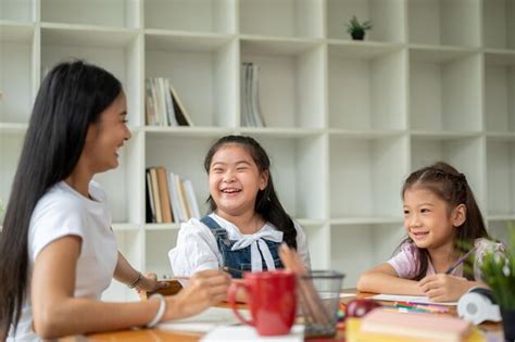 Premium Photo Two Adorable Young Asian Girls Are Enjoying Studying