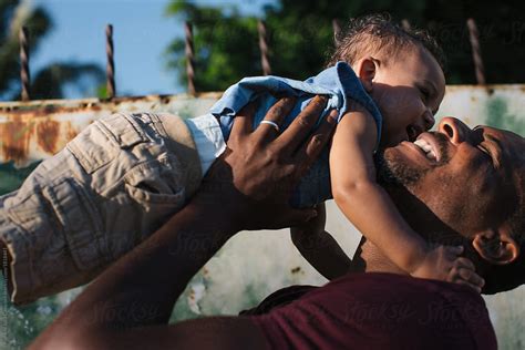 Young Dad Enjoying Son Outside On Sunny Day By Stocksy Contributor